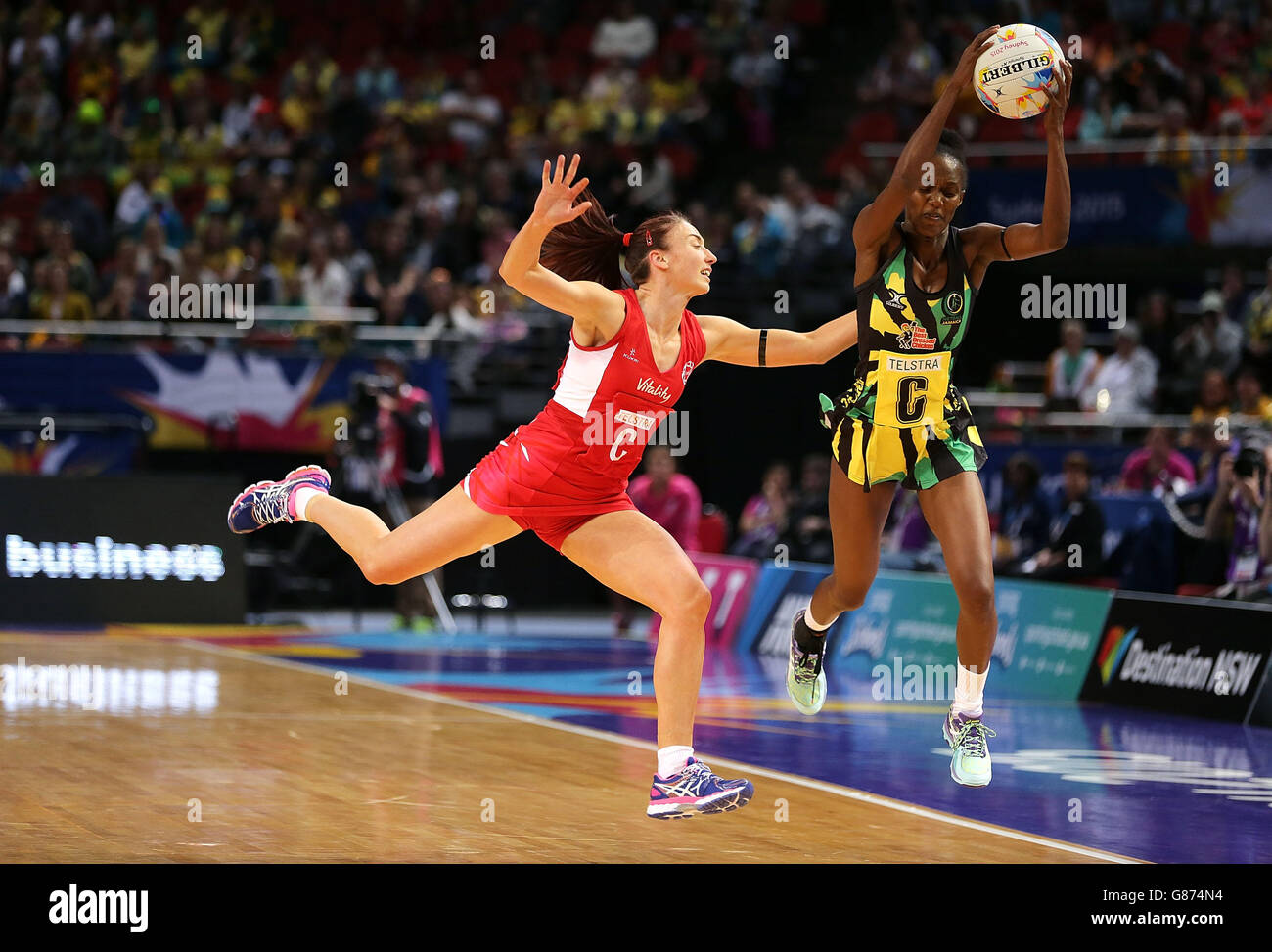 England's Jade Clarke and Jamaica's Paula Thompson compete for the ball ...