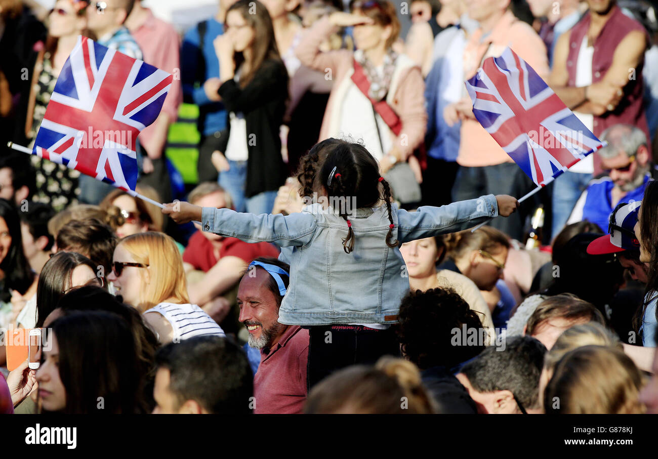 Two young girls play with union flags in the centre of the roundabout ...