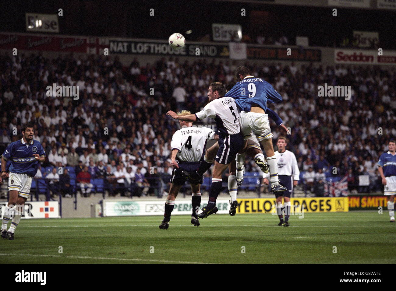 Everton's Duncan Ferguson (r) beats Bolton Wanderers' Gerry Taggart ...