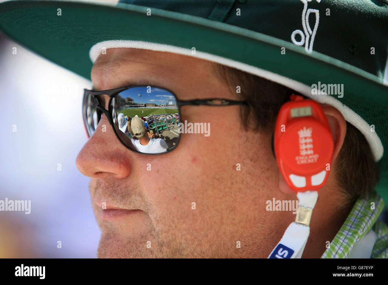 A fan watches the action while listening to the match commentary Stock ...