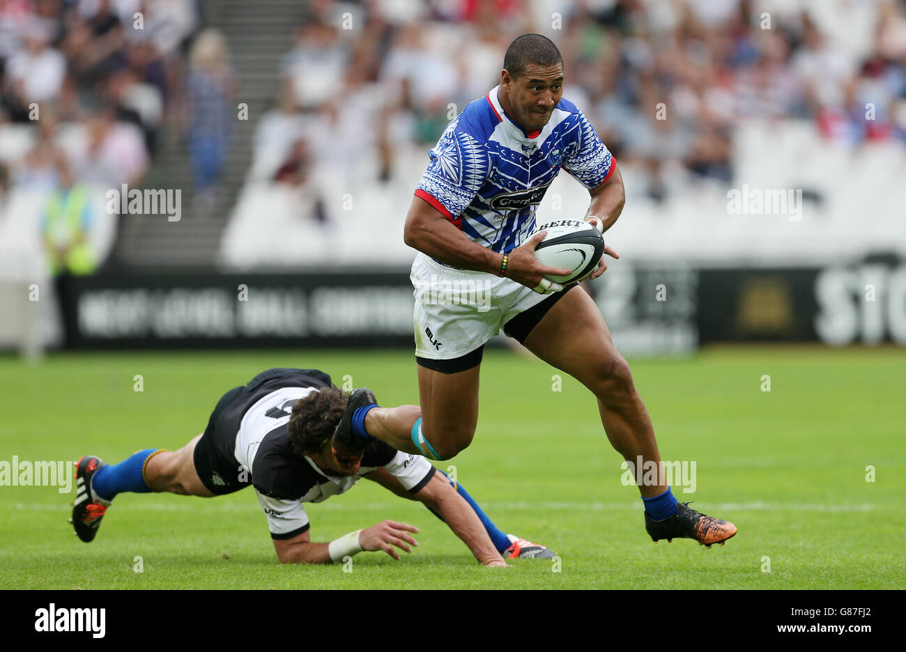 Samoa's Paul Perez gets away from Barbarians Luke Burgess during the ...