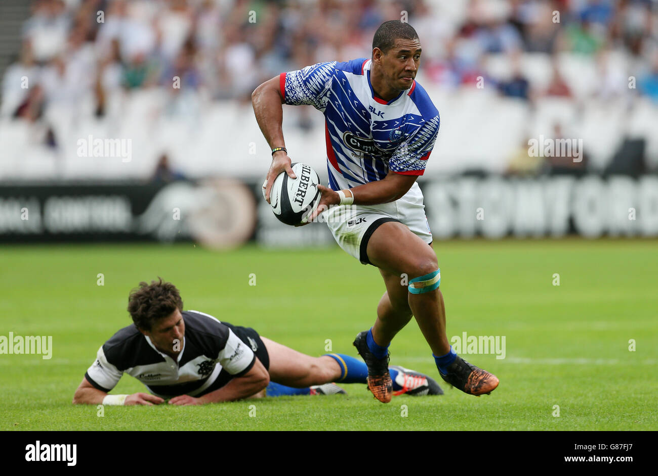 Samoa's Paul Perez gets away from Barbarians Luke Burgess during the ...