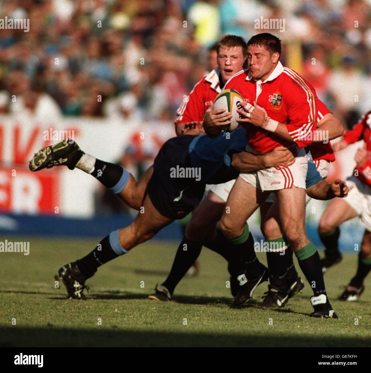 Alan Tait, British Lions, is tackled by the Northern Transvaal defence ...