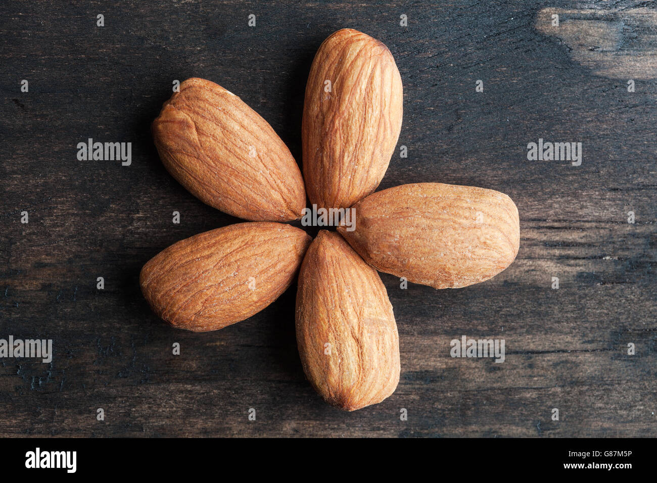 Almonds arranged in flower shape closeup with copy space Stock Photo ...