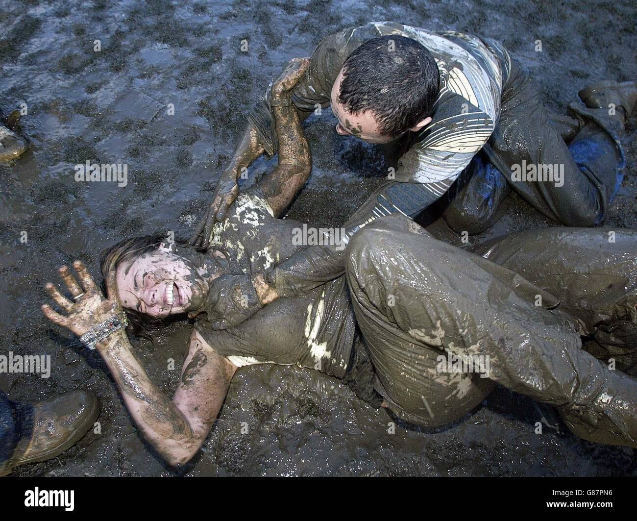 Radio One, One Big Weekend. Music fans play in the mud Stock Photo - Alamy