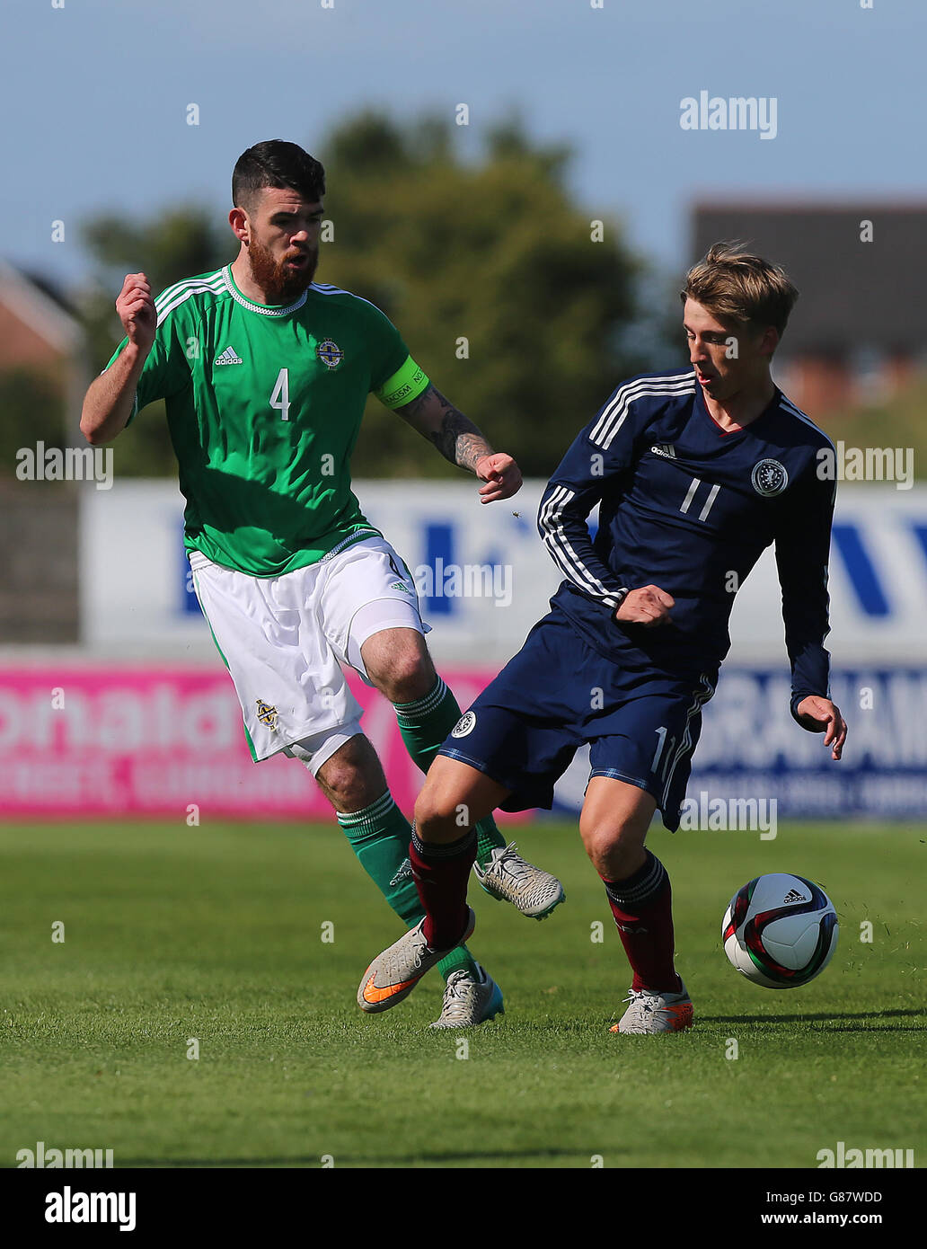 Northern Irelands Liam Donnelly tackles Scotlands Ryan Gauld during the ...