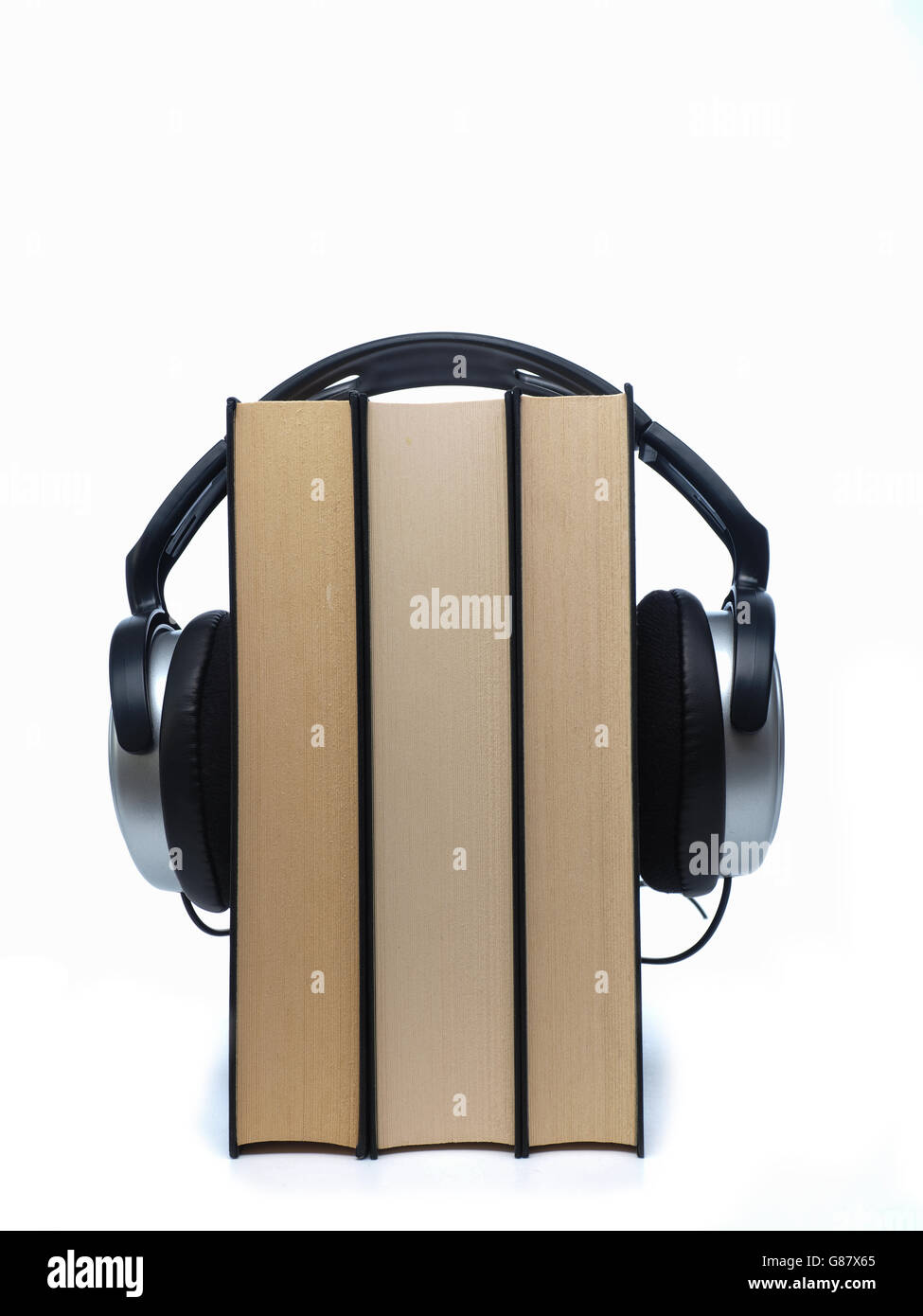 Books with headphones on a white background Stock Photo - Alamy