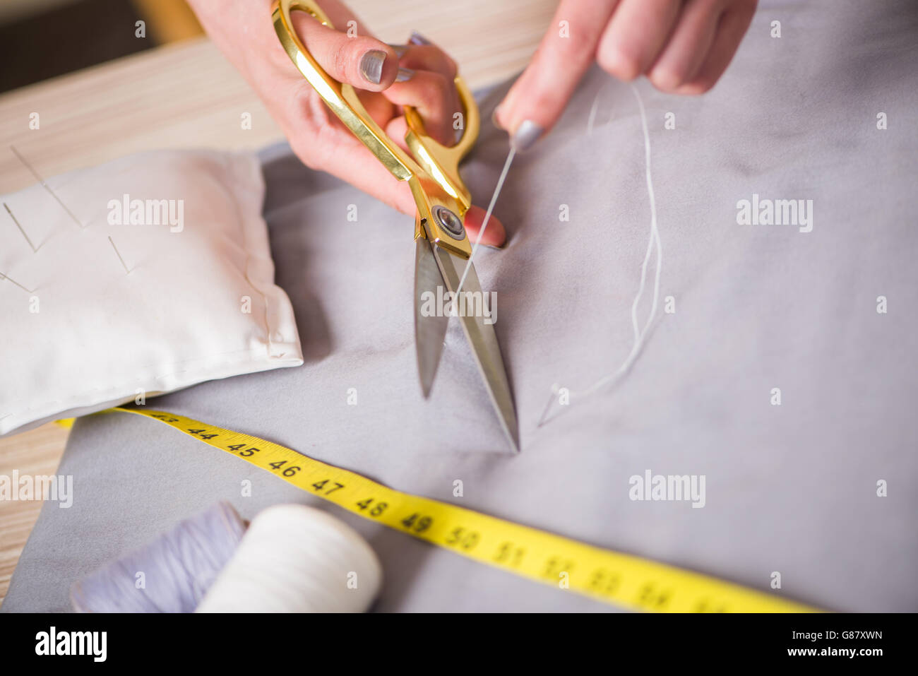 Tailor hands working on new clothing Stock Photo - Alamy