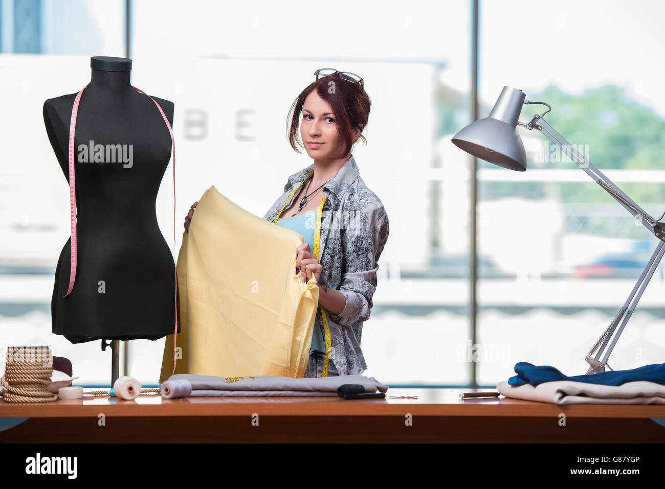 Woman tailor working on new clothing Stock Photo - Alamy