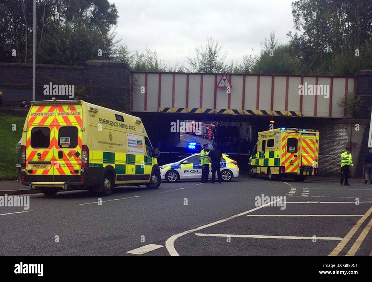The scene after a double-decker bus crashed into a bridge, ripping its ...
