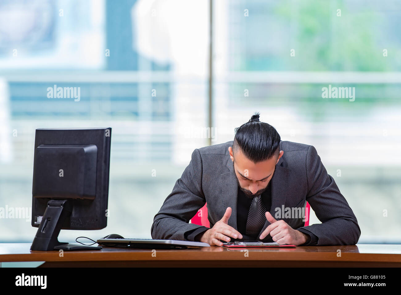 Sad businessman sitting in the office Stock Photo - Alamy