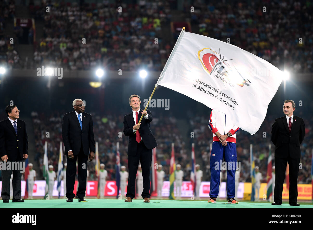 UK Athletics president Lynn Davies waves the IAAF flag as outgoing IAAF ...