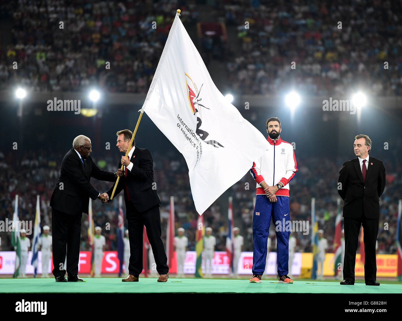 Outgoing IAAF president Lamine Diack hands over the IAAF flag to UK ...