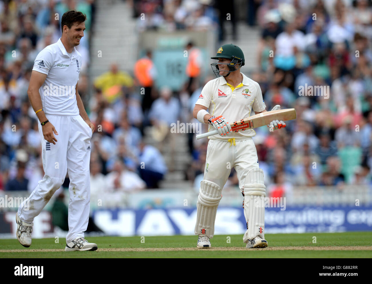 England's Steven Finn shares a laugh with Australia's David Warner ...
