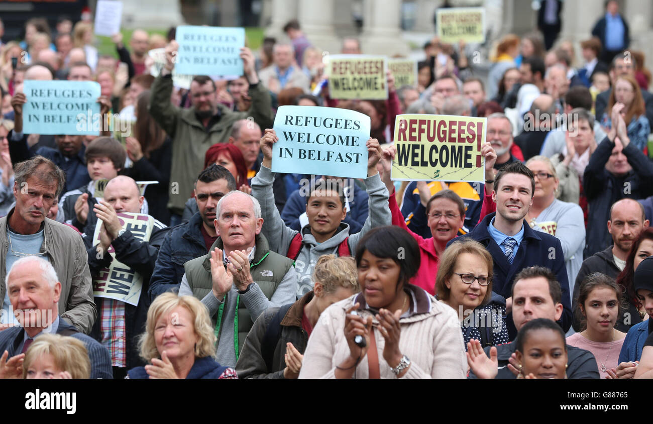People attend a vigil for refugees outside Belfast City Hall as Deputy ...