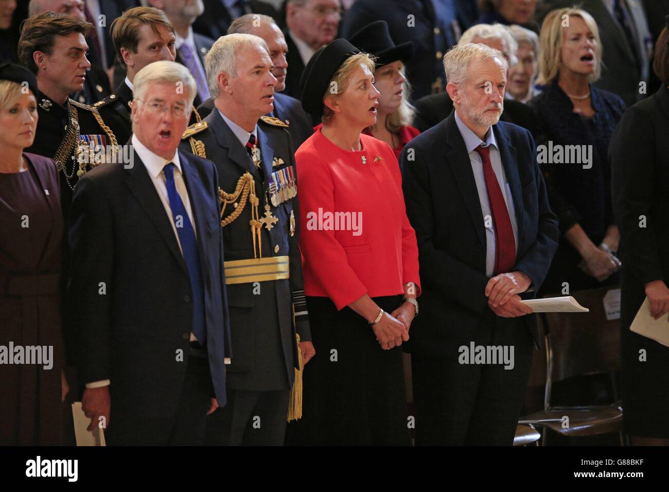 Leader of the Labour Party Jeremy Corbyn (right) stands as the national ...