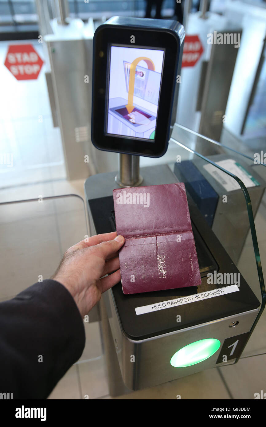 A person uses a biometric passport reader while passing through ...