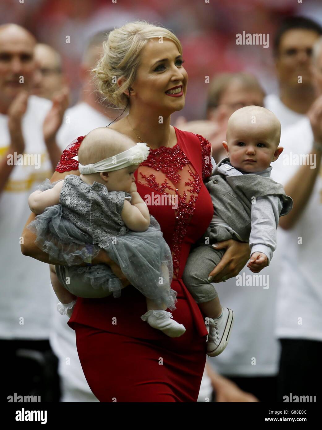 Lizzie Jones, Widow of Danny Jones, leaves the pitch with her children ...