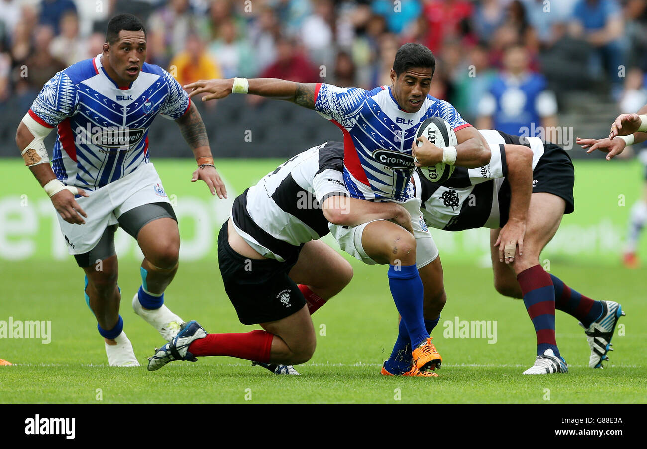 Samoa's Ken Pisi is tackled by Barbarians' Liam Gill and Carl Hayman ...