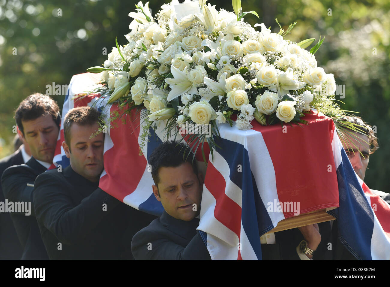 The coffin of Indycar racer Justin Wilson is carried by Mark Webber ...