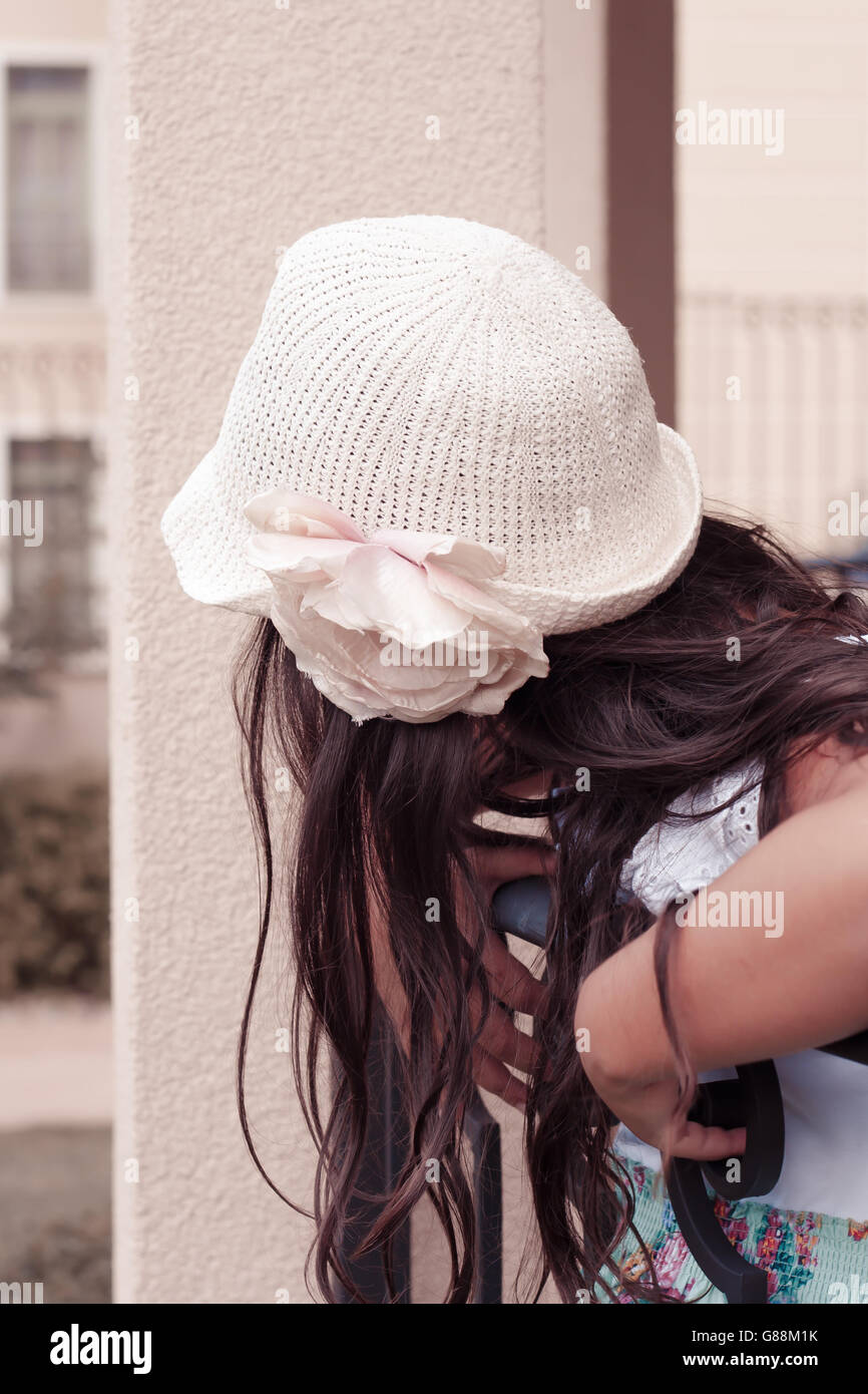Rear view of a girl looking over balcony Stock Photo - Alamy
