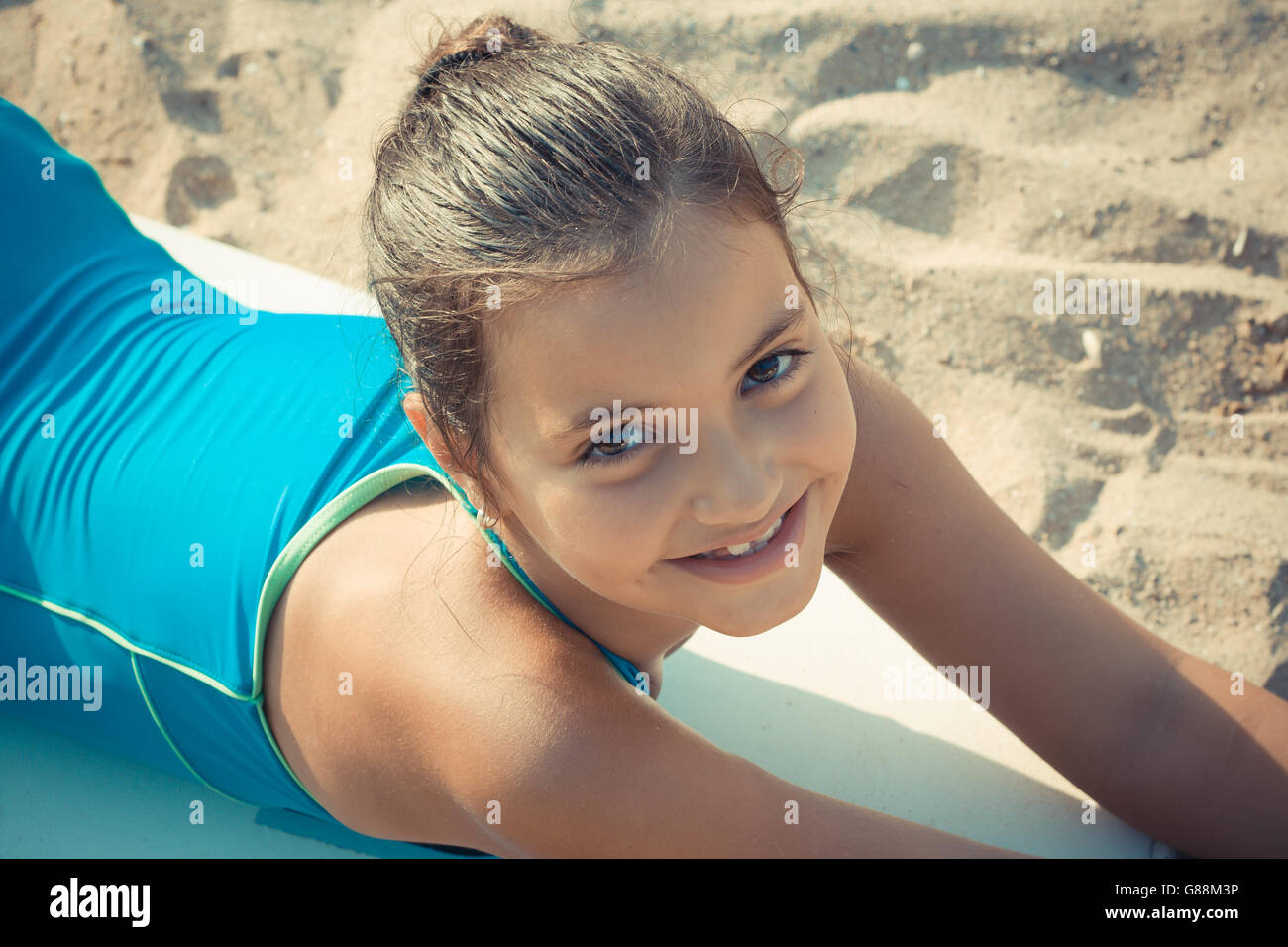 Little Girl Lying Down On Beach at Mason Kumm blog