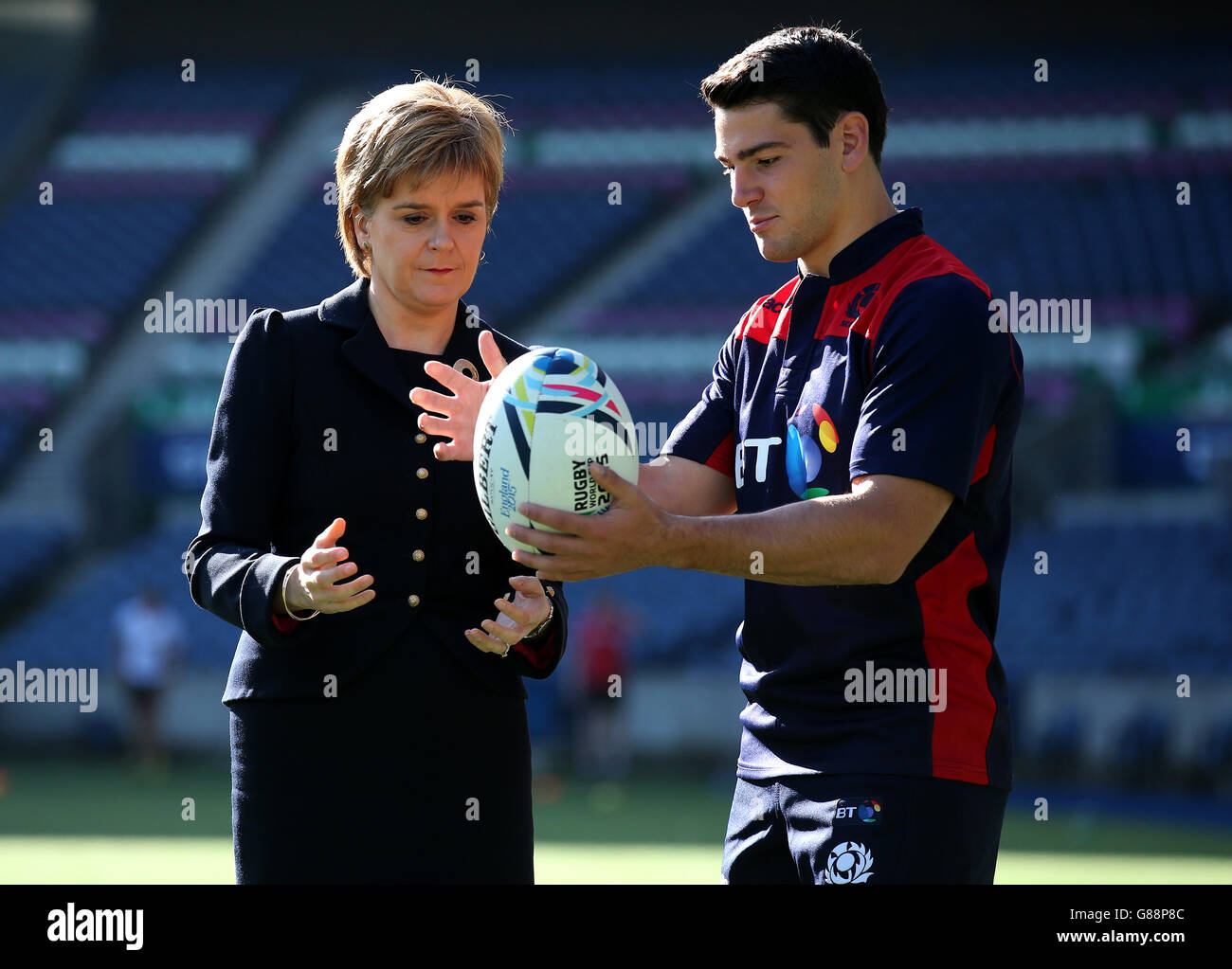 First Minister Nicola Sturgeon is shown how to throw a rugby ball by ...