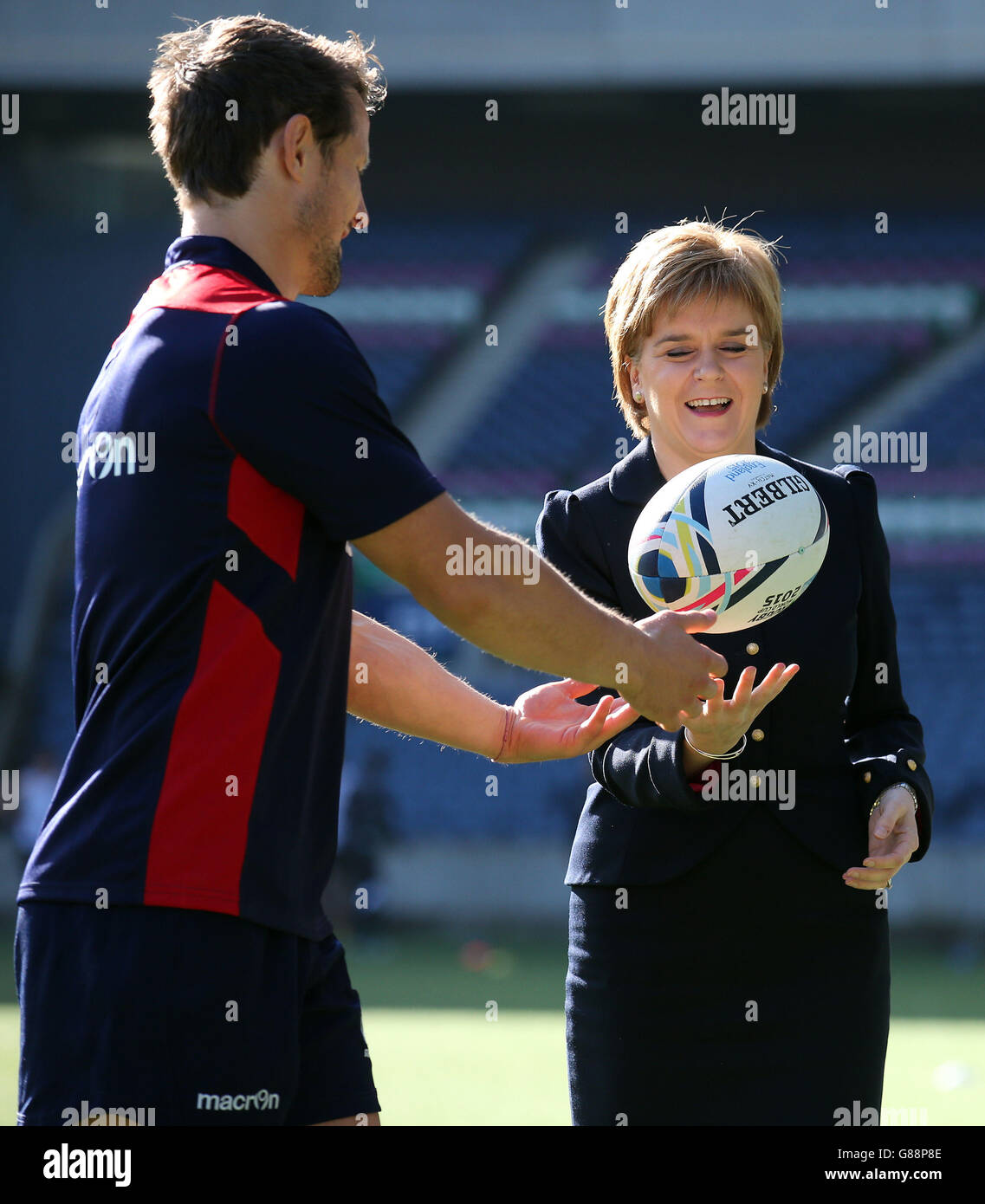 First Minister Nicola Sturgeon throws a rugby ball with player Peter ...