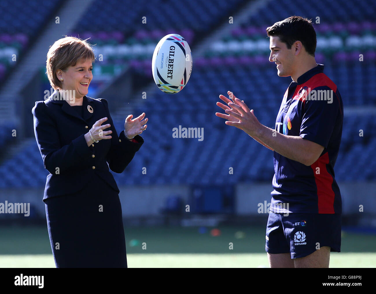 First Minister Nicola Sturgeon throws a rugby ball with player Samuel ...