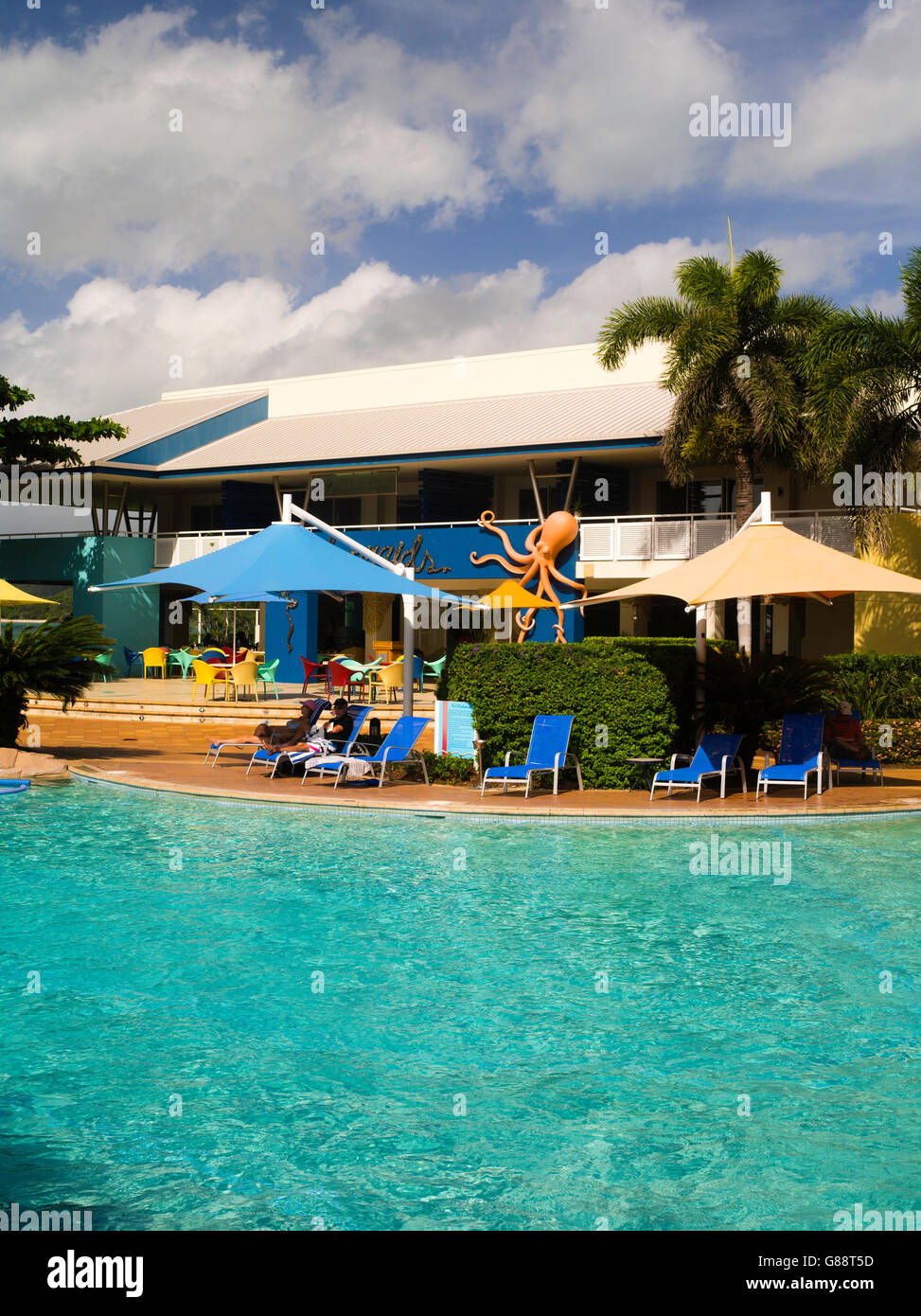 Relaxing by the pool at Daydream Island Resort; Whitsunday Islands, QLD ...