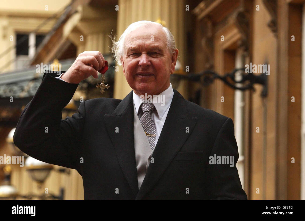 Former Wales and British Lions rugby star Bleddyn Williams holds up his ...