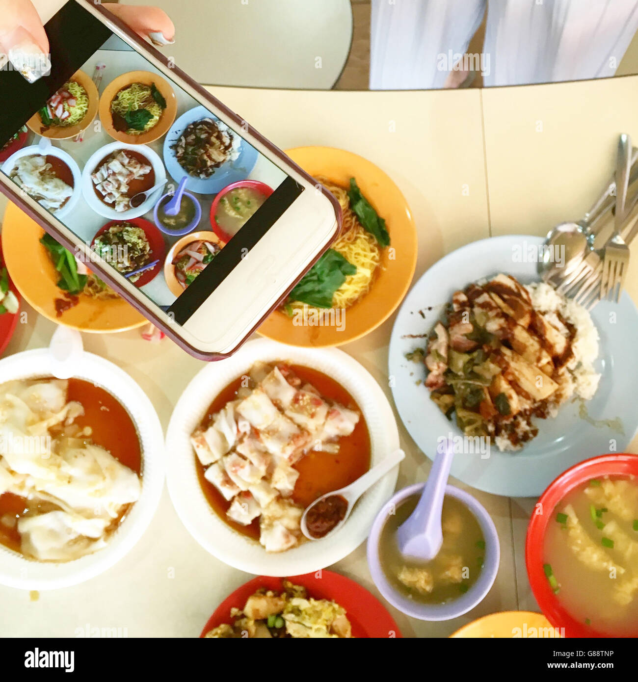 Woman photographing food with mobile phone Stock Photo - Alamy