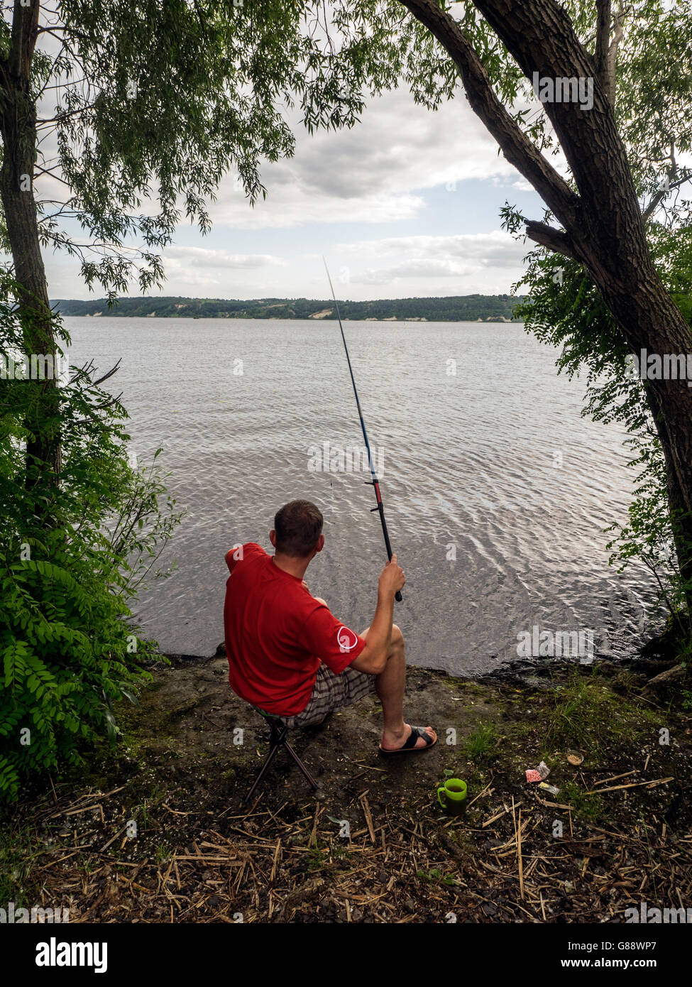 Man sitting fishing hi-res stock photography and images - Alamy