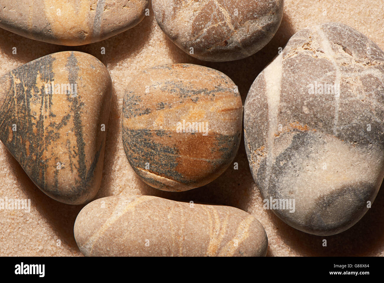 Close up of sea stones on sand. Summer beach background. View from ...