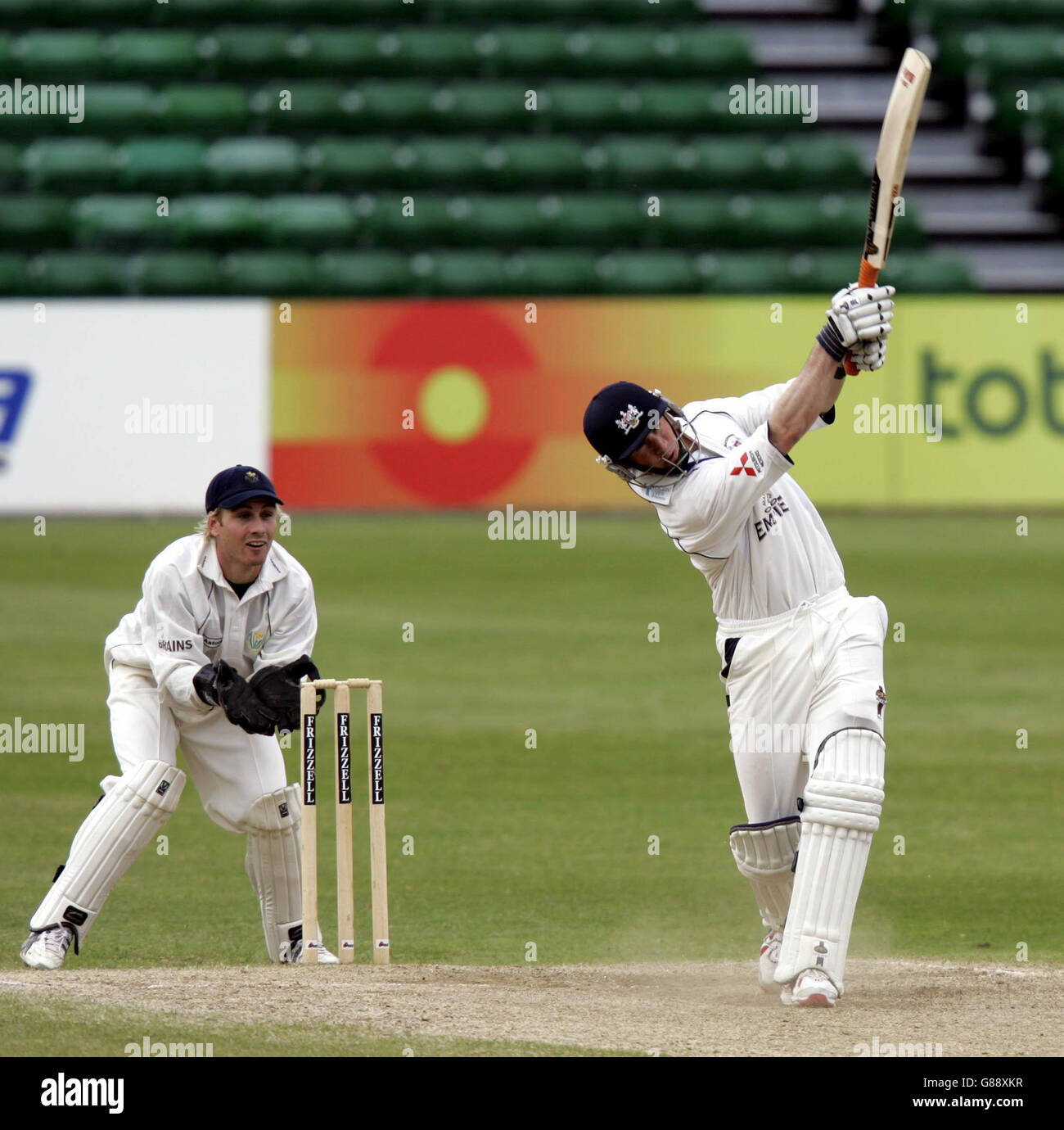 Gloucestershire's Tim Hancock (R) smashes a six during his innings of ...