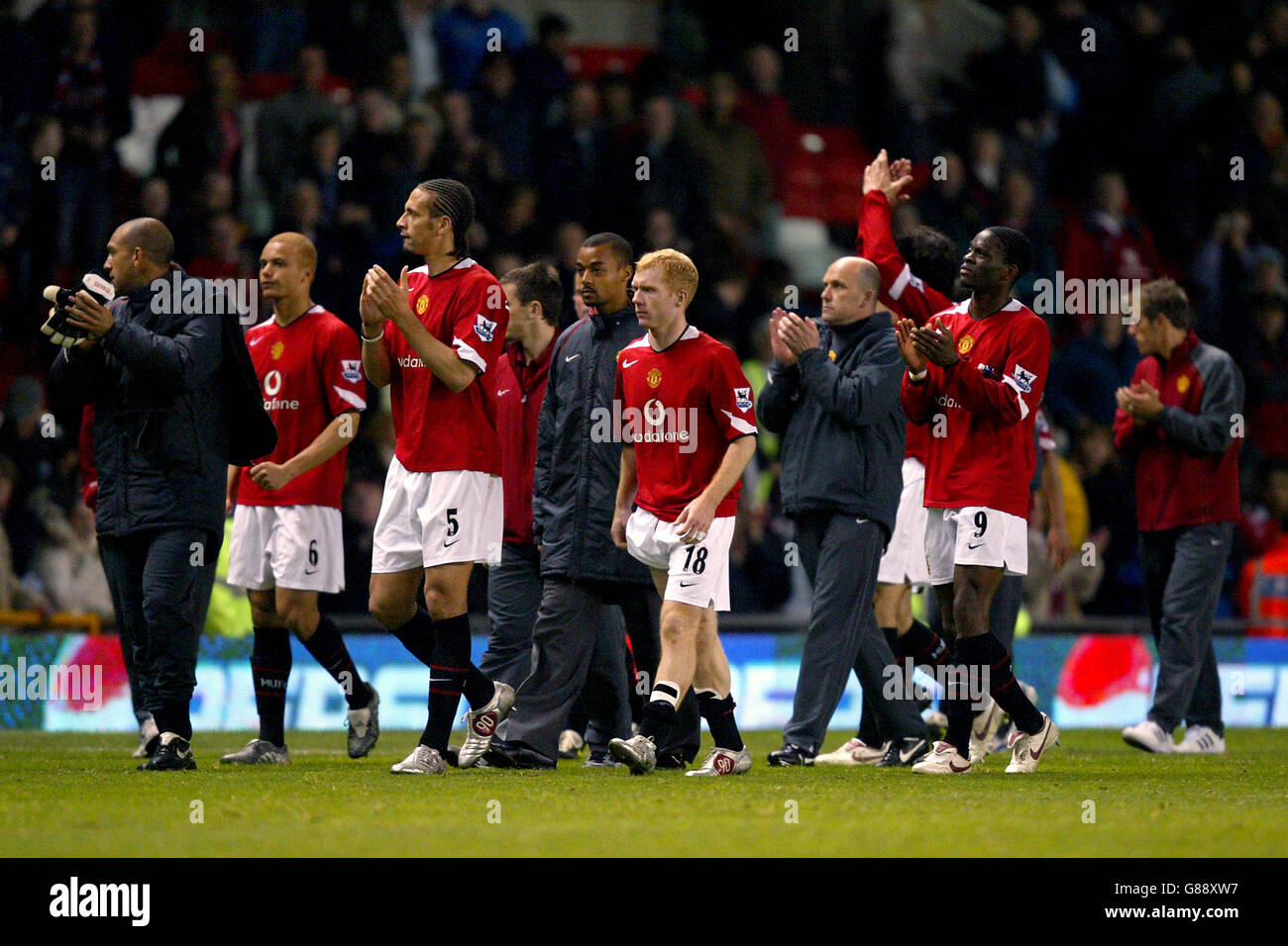 Manchester United players look dejected as they are lead on a lap of ...