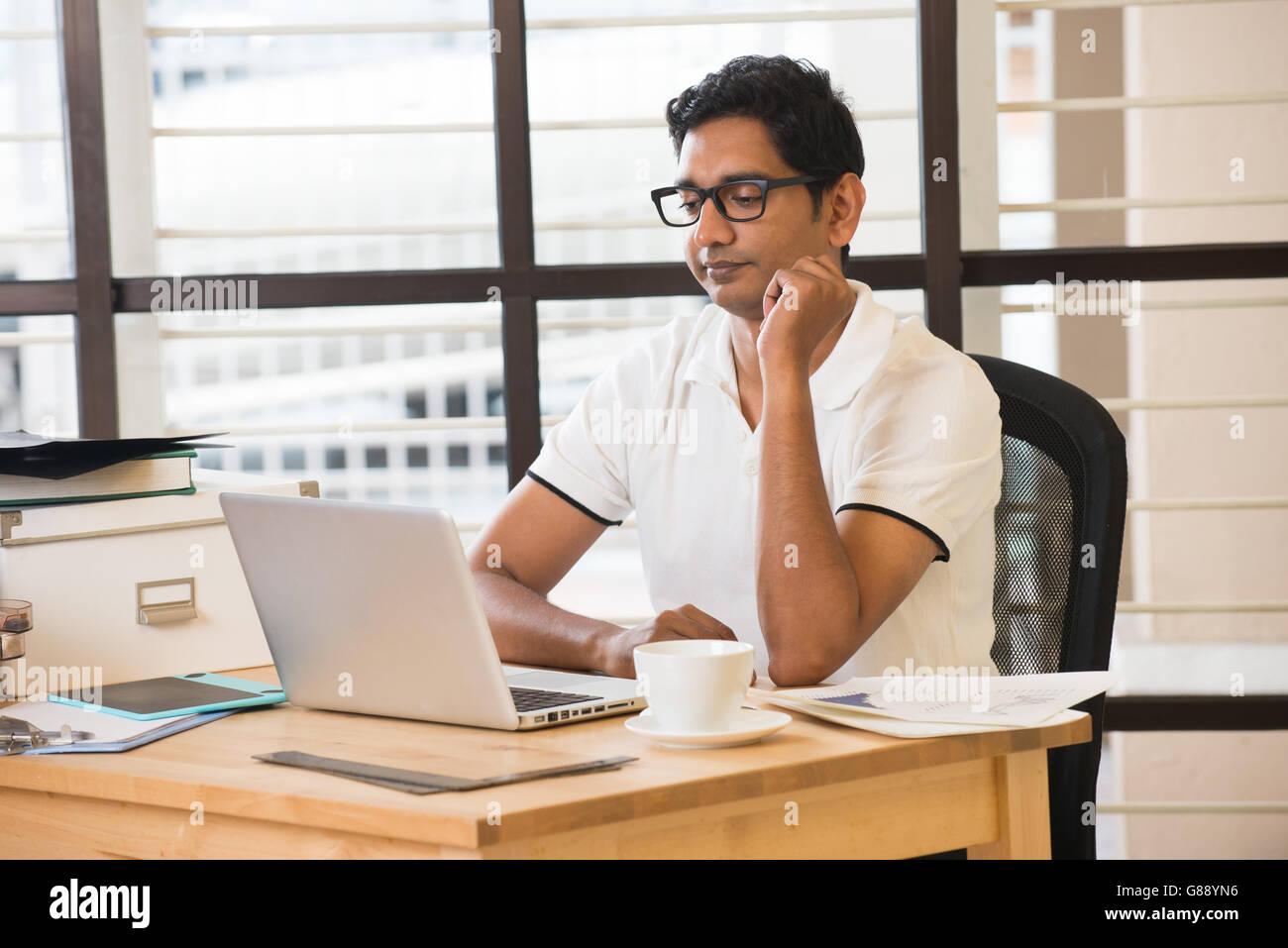 casual indian man working at office Stock Photo - Alamy