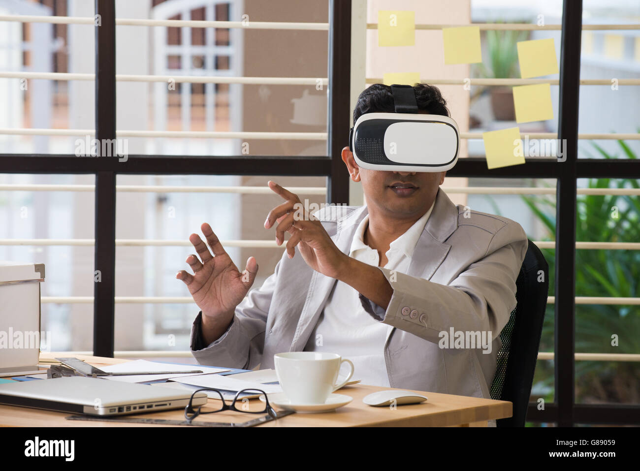 indian male using virtual reality technology at work Stock Photo - Alamy