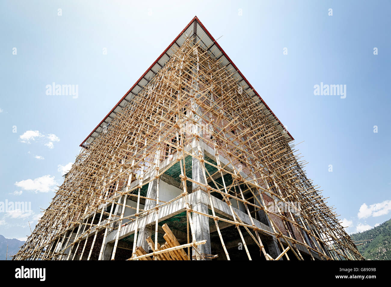 Building under construction with bamboo scaffolding Stock Photo - Alamy