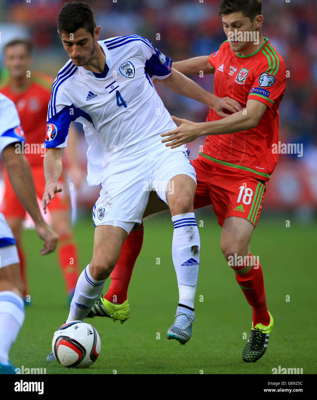 Israel's Nir Biton (left) and Wales' Ben Davies battle for the ball ...