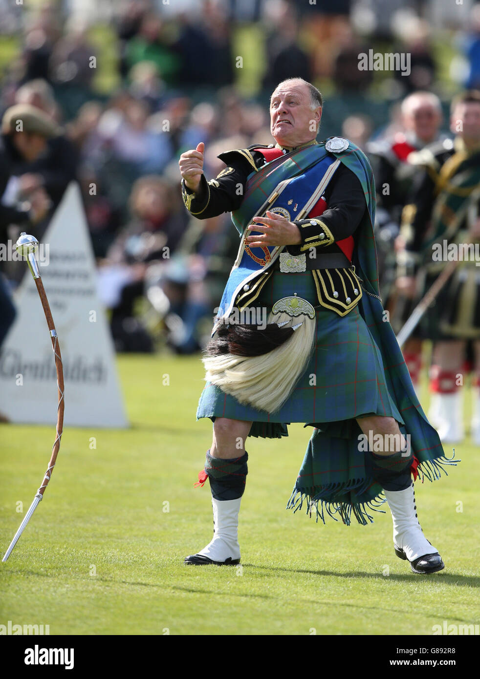 A Pipe Major trys to catch his staff during a competition at the ...
