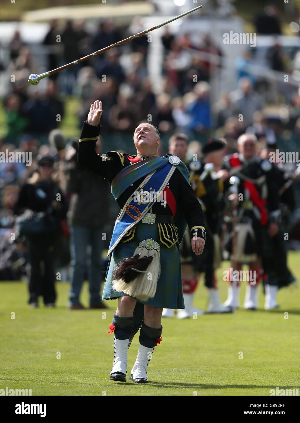 A Pipe Major trys to catch his staff during a competition at the ...