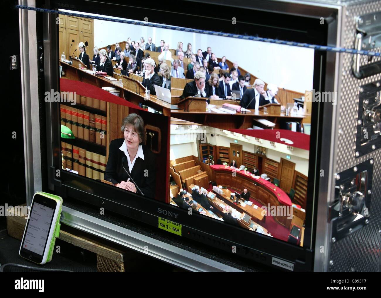 Lady Paton (bottom left) is shown on a TV monitor, from camera footage ...