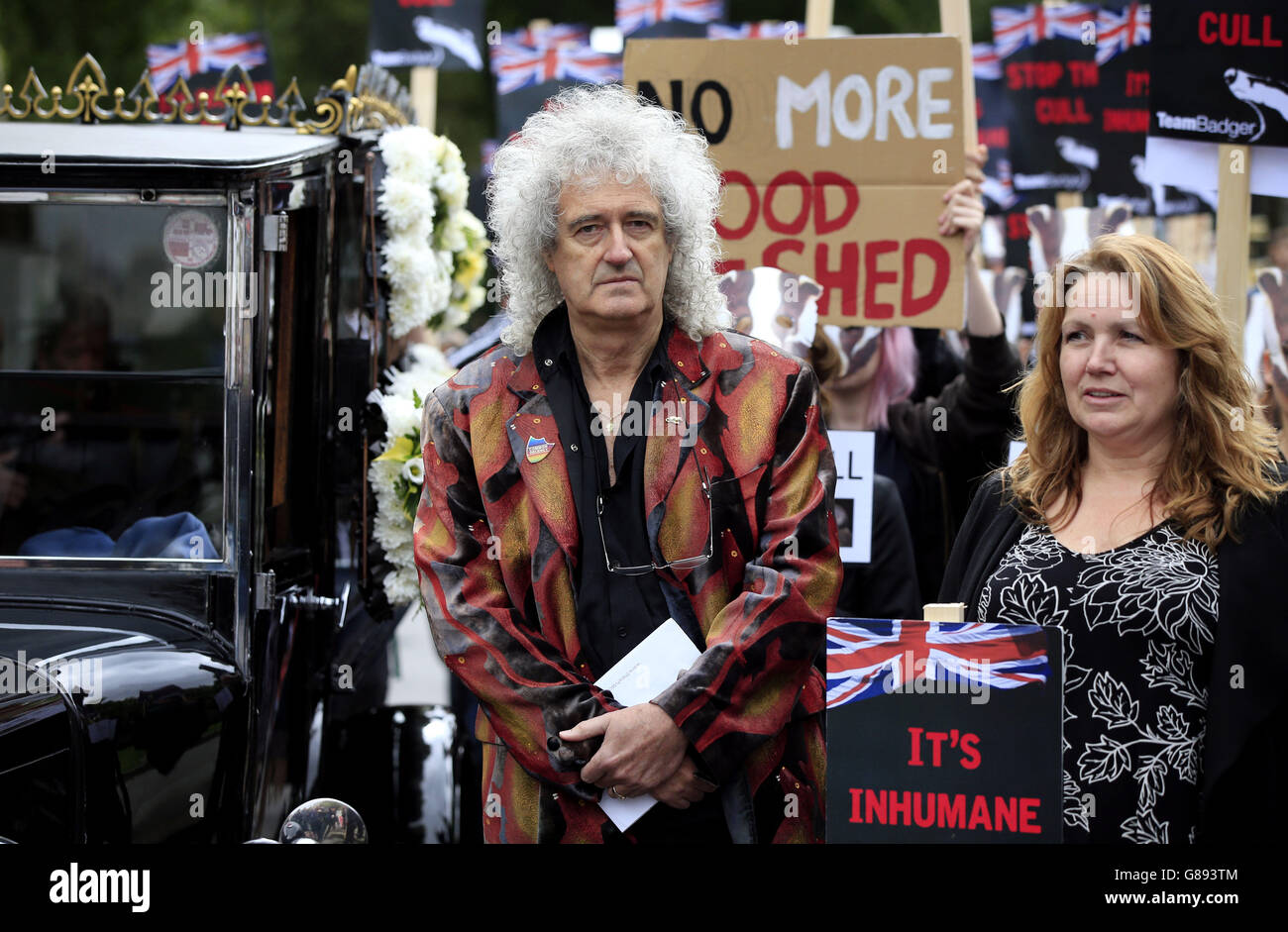Queen guitarist Brian May leads a Team Badger protest march mimicking a ...