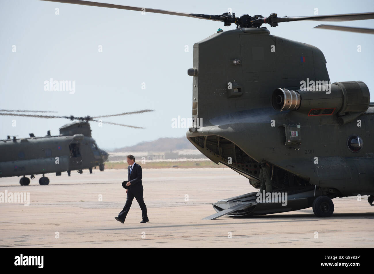 Prime Minister David Cameron walks from a Chinook helicopter after ...