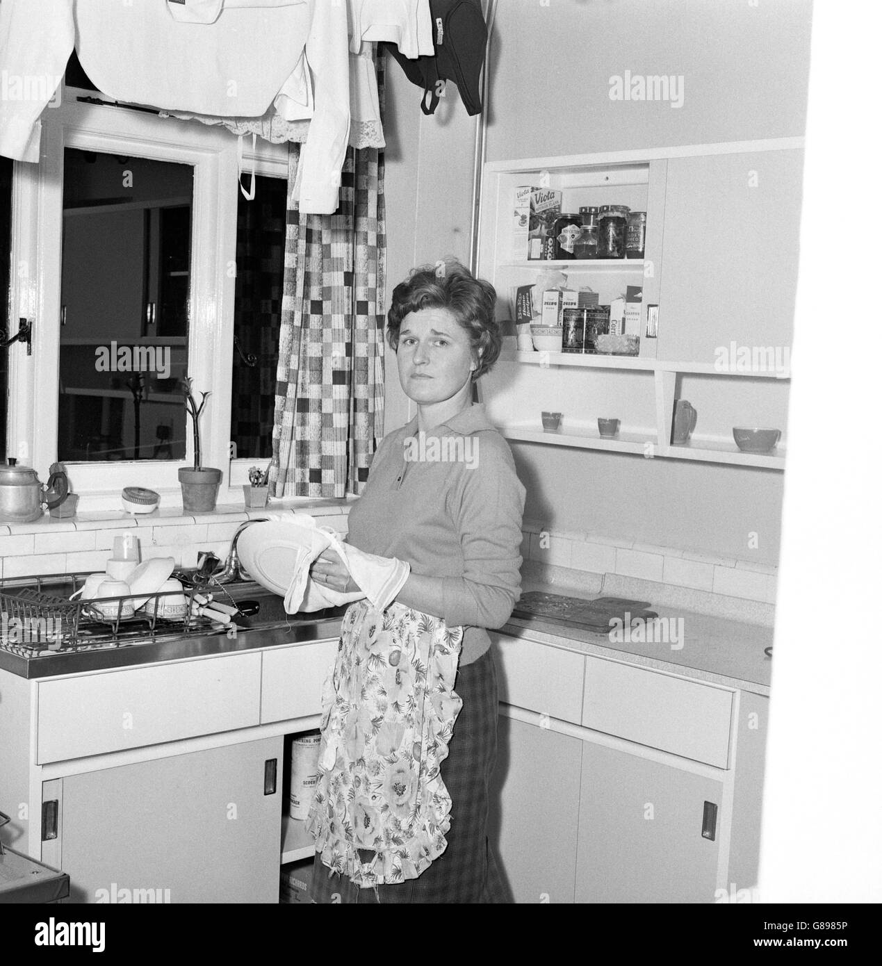 Mrs E Skinner doing the washing up Stock Photo - Alamy