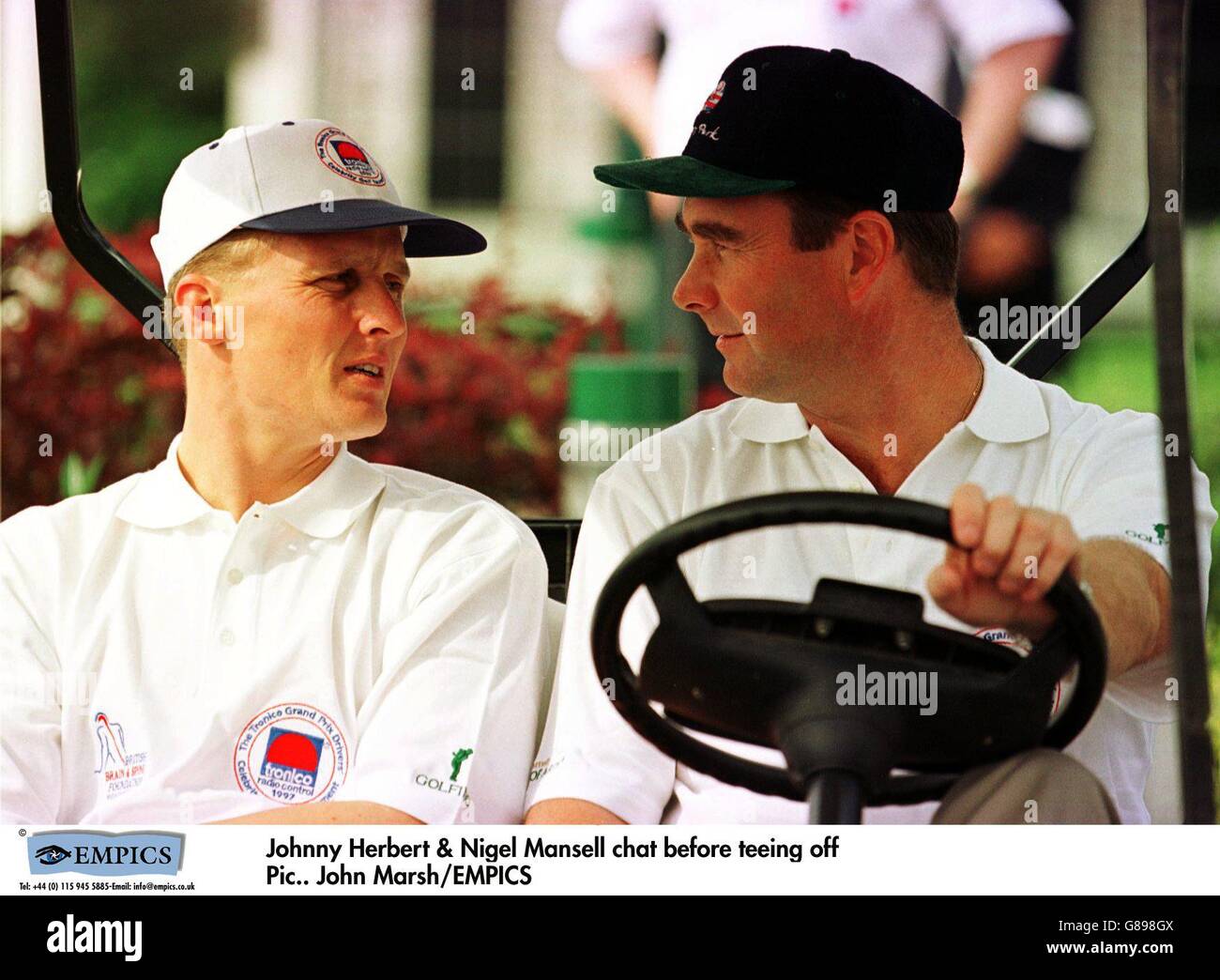 Johnny Herbert & Nigel Mansell chat before teeing off Stock Photo - Alamy