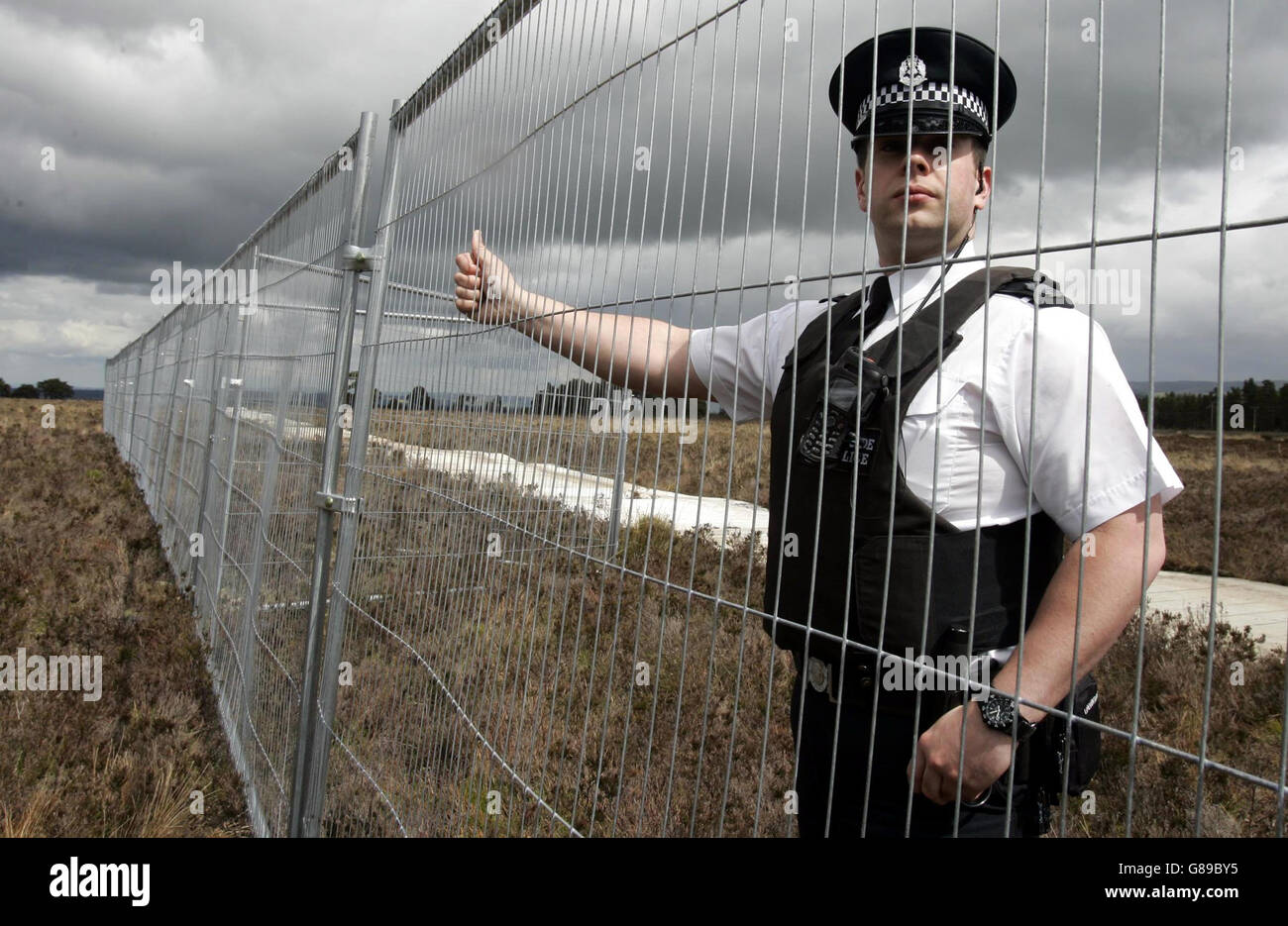 A police officer inspects the newly erected 5km perimeter fence around ...
