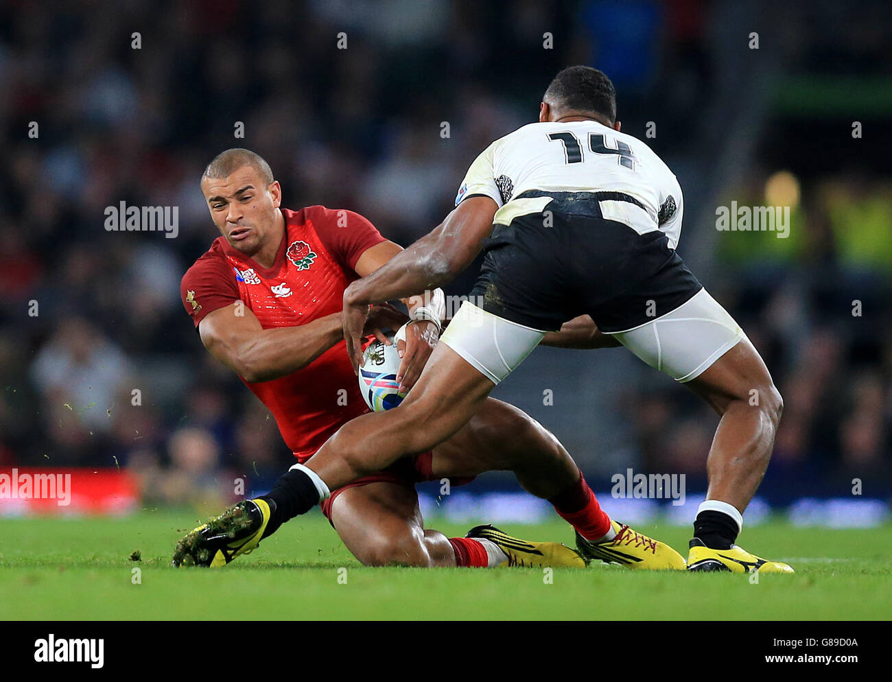 England's Jonathan Joseph (left) and Fiji's Waisea Nayacalevu in action ...