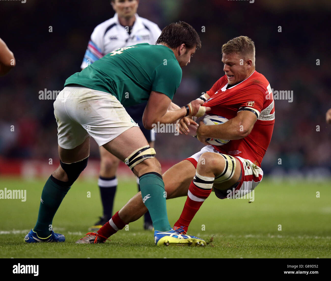 Ireland's Iain Henderson tackles Canada's Conor Trainor (right) during ...